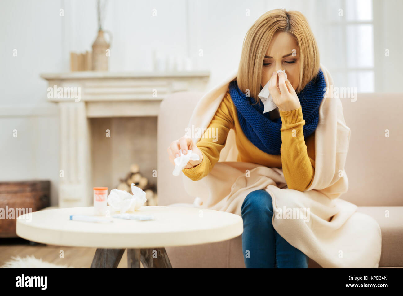 Blond woman feeling bad and having runny nose Stock Photo - Alamy