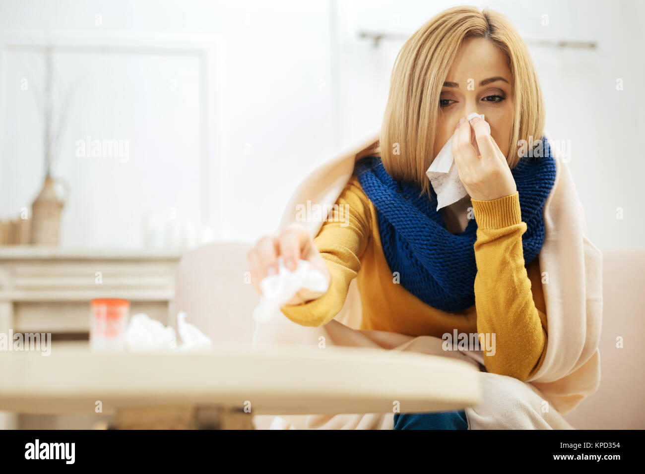 Ill lady feeling bad and sitting on the couch Stock Photo - Alamy