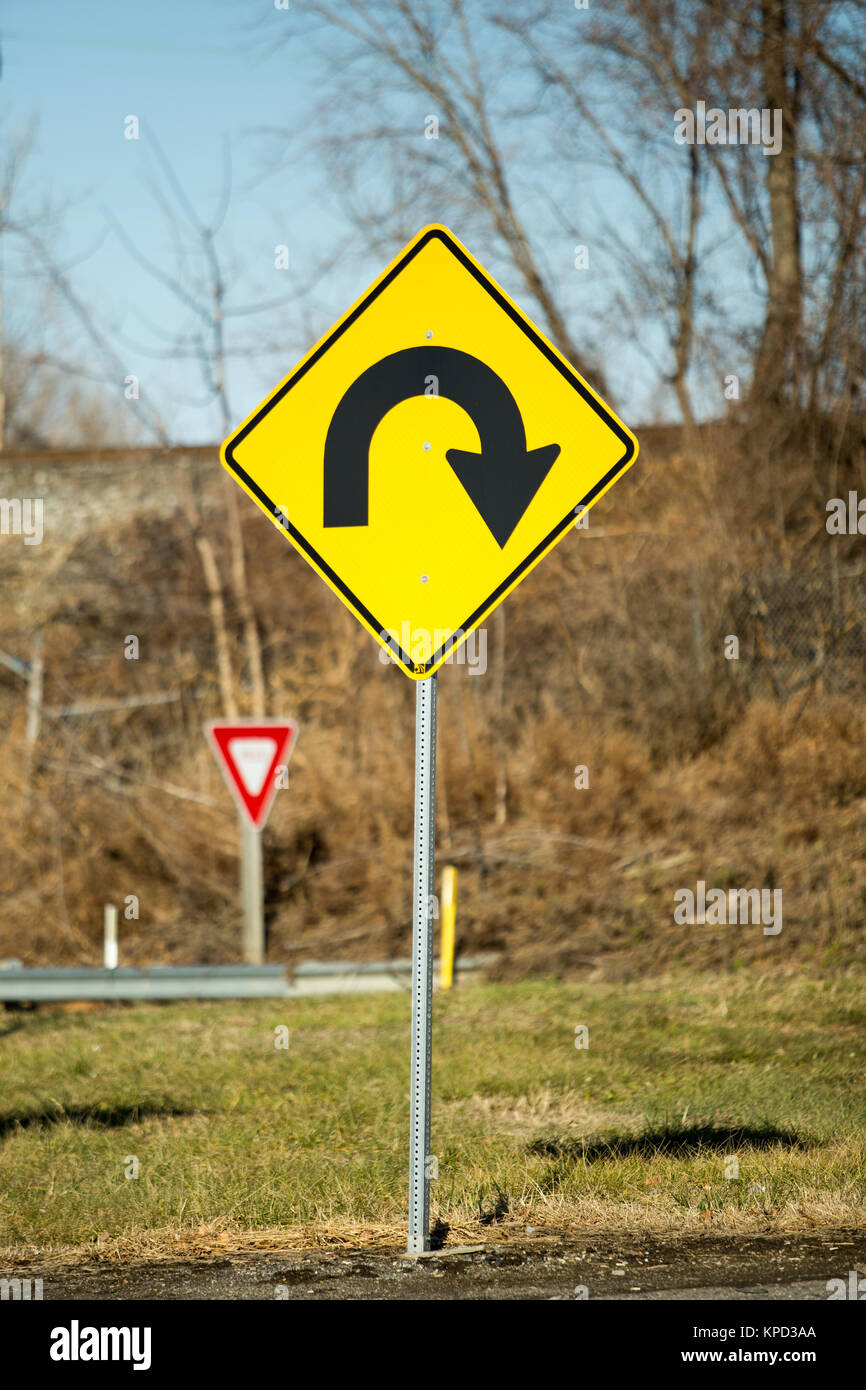 A yellow directional sign with black arrow directing to go right and ...