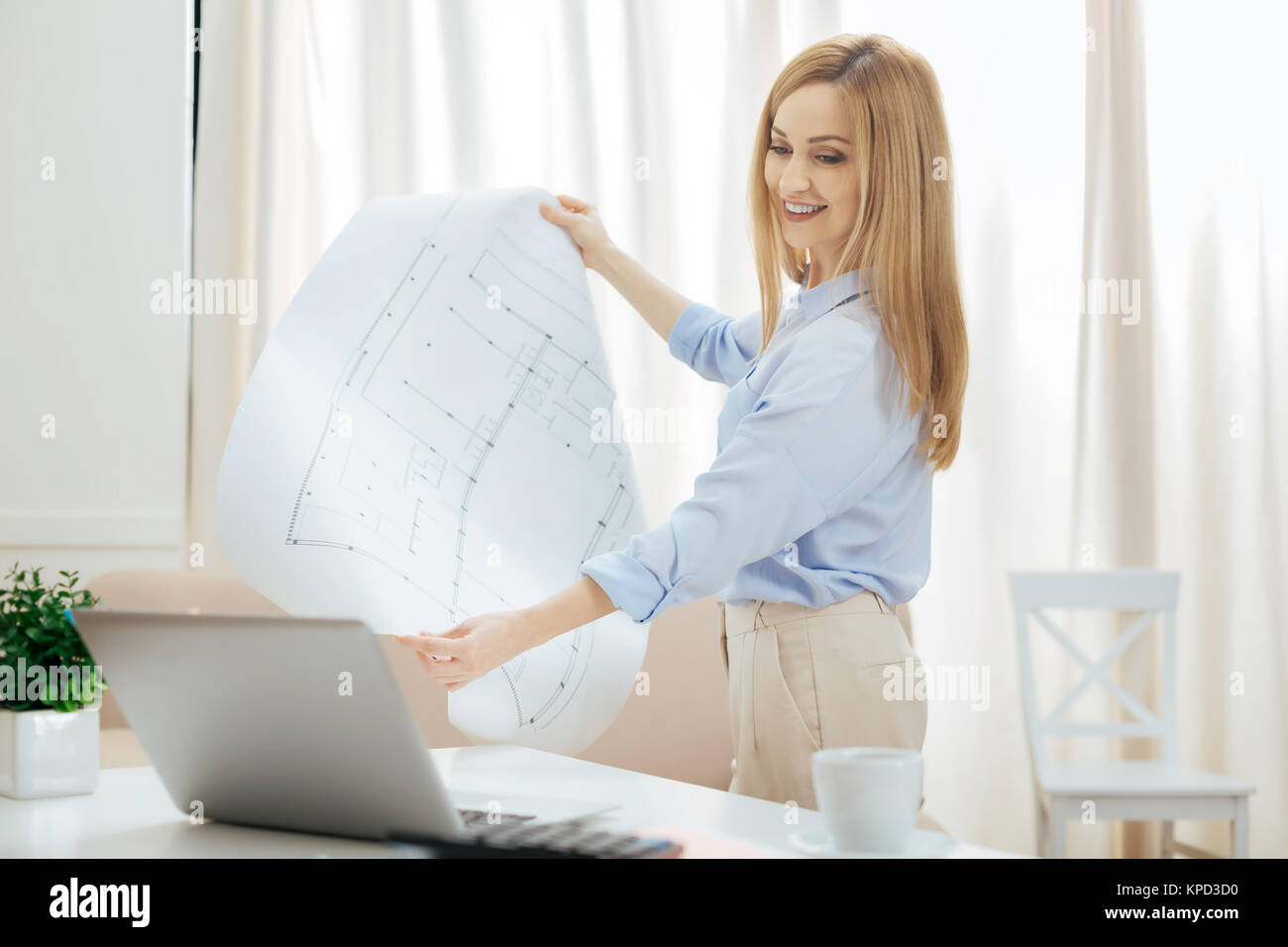 Inspired woman holding a big drawing Stock Photo - Alamy