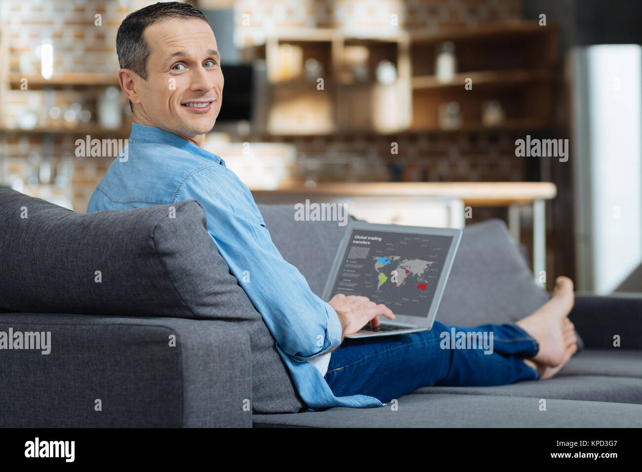 Cheerful freelancer working with his laptop Stock Photo - Alamy
