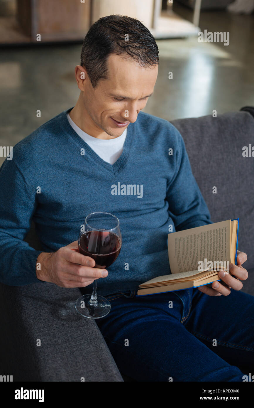 Attentive man looking at his book Stock Photo - Alamy