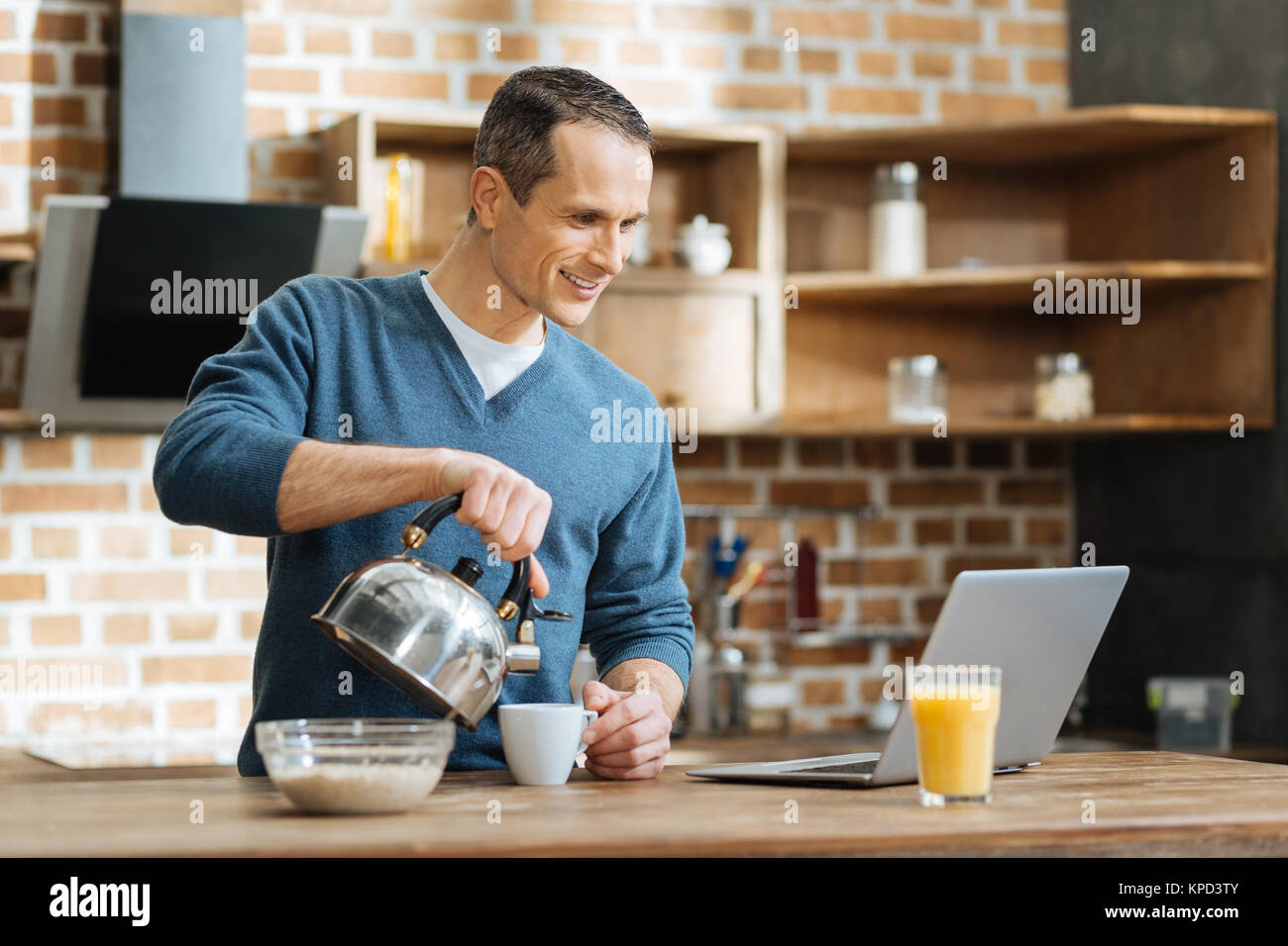Delighted man making fresh coffee Stock Photo - Alamy