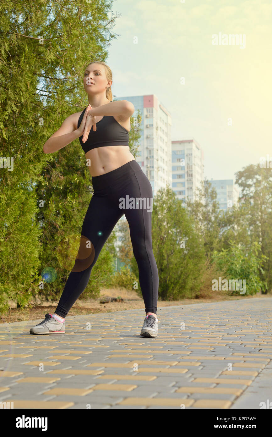 She is a sport girl! Girl doing stretching exercises before Jogging ...