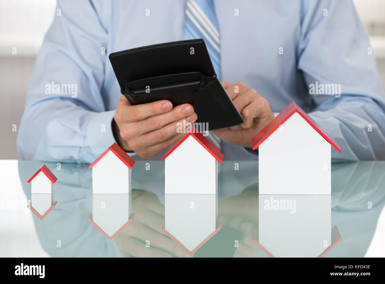 Businessman Doing Calculation On Calculator Stock Photo - Alamy
