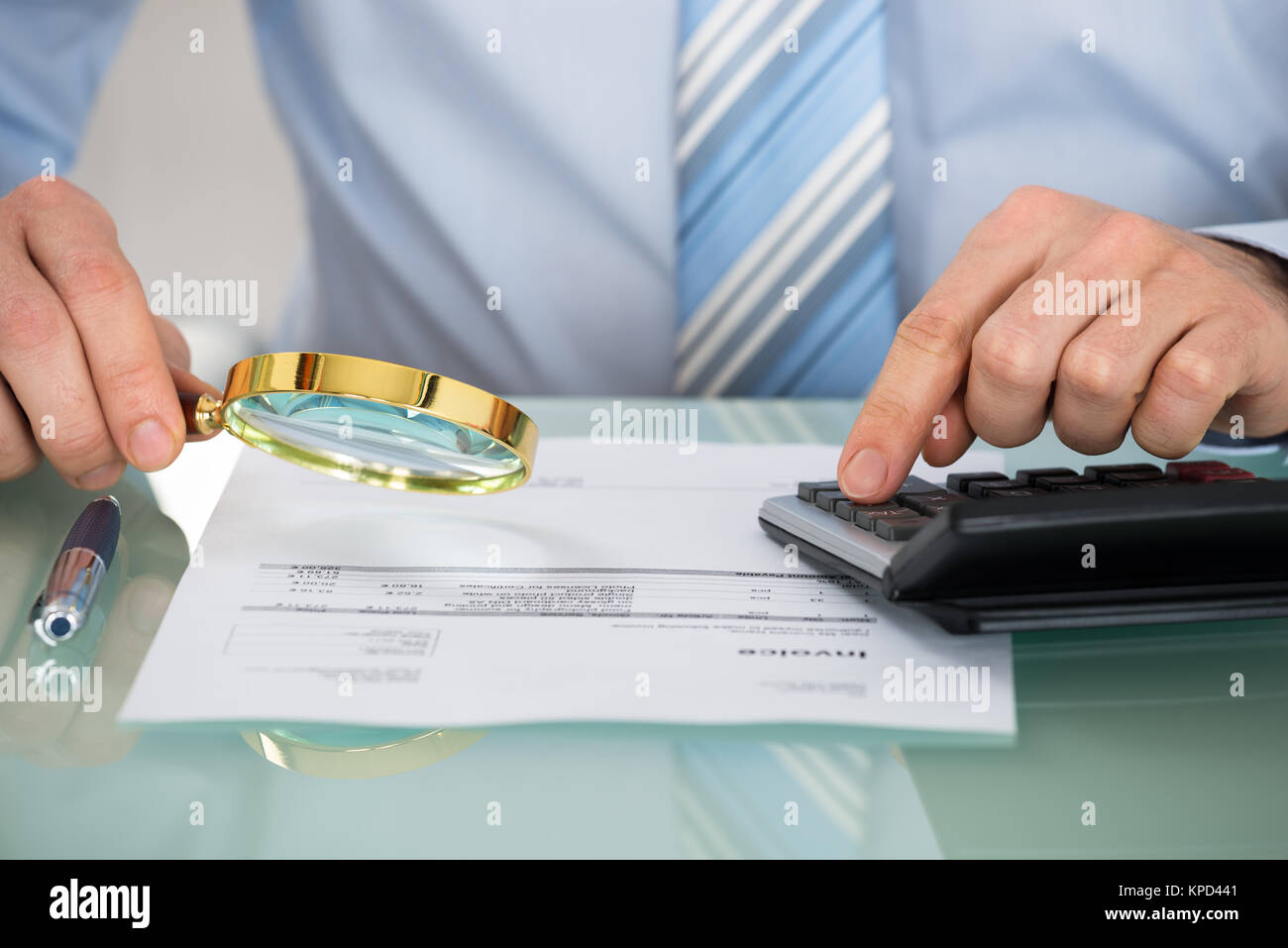 Businesswoman Checking Invoice With Magnifying Glass Stock Photo - Alamy