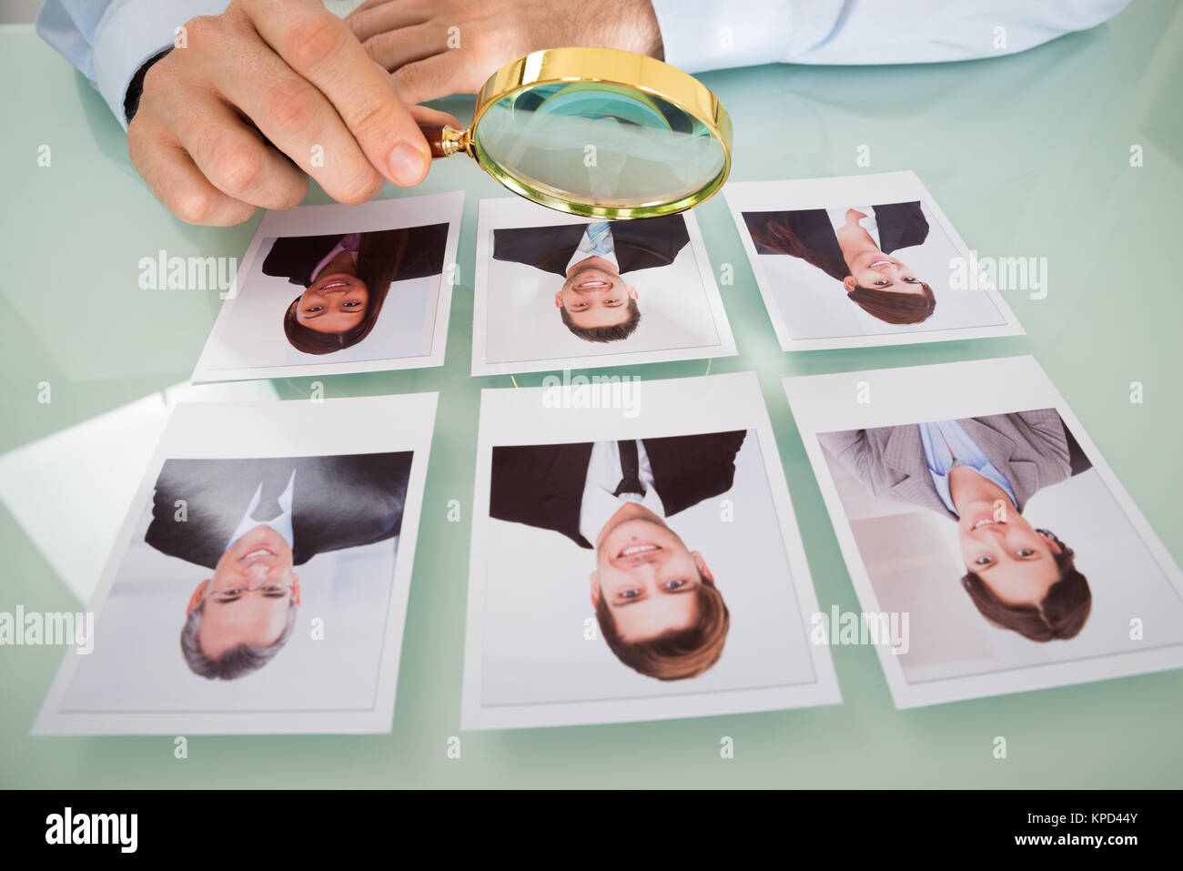 Person With Candidate Photograph And Magnifying Glass Stock Photo - Alamy