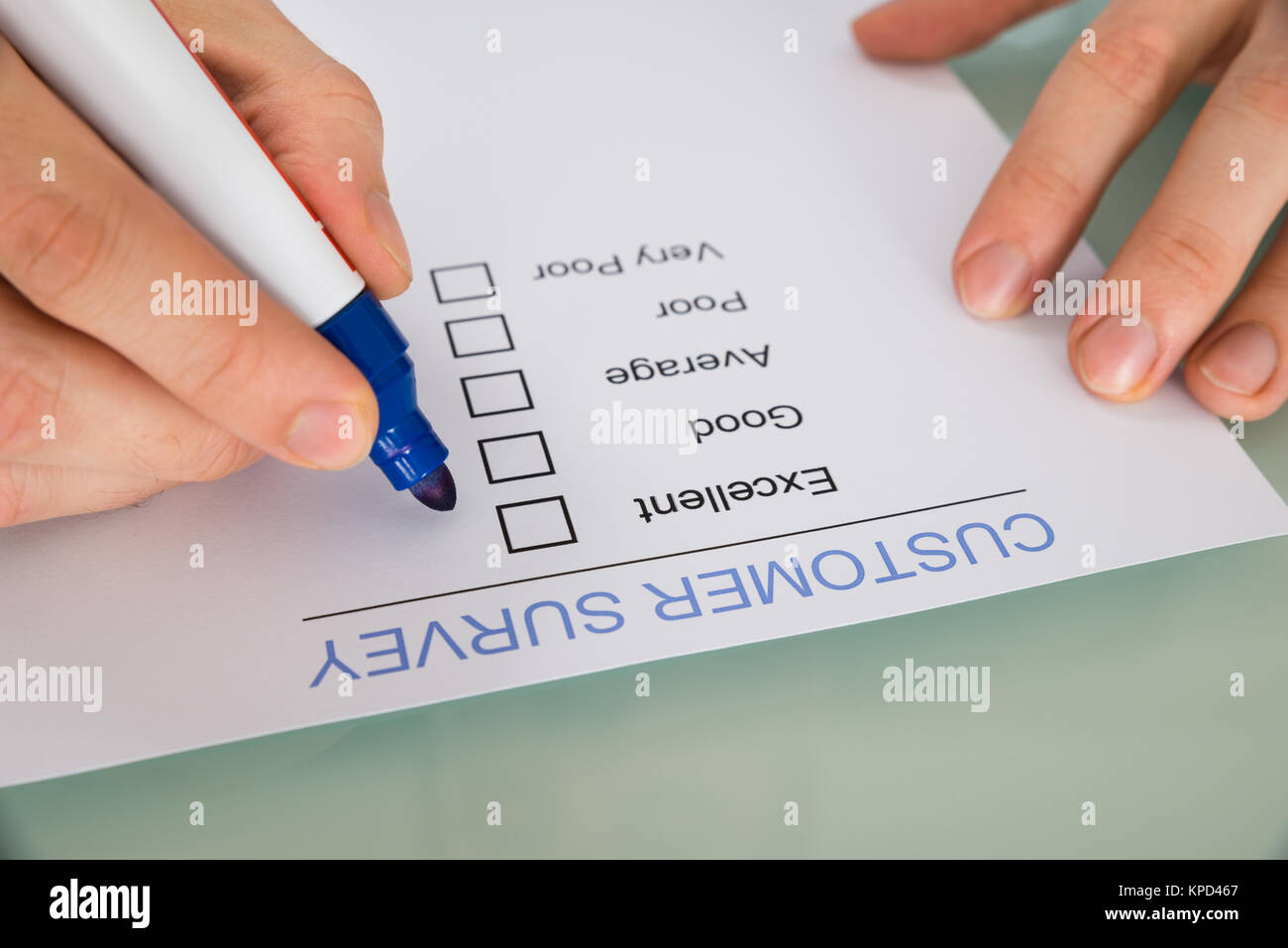 Person Hand Marking On Customer Survey Form Stock Photo - Alamy