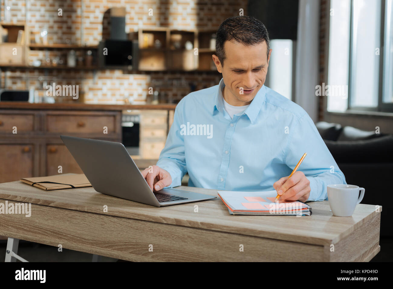 Positive businessman preparing his project Stock Photo - Alamy