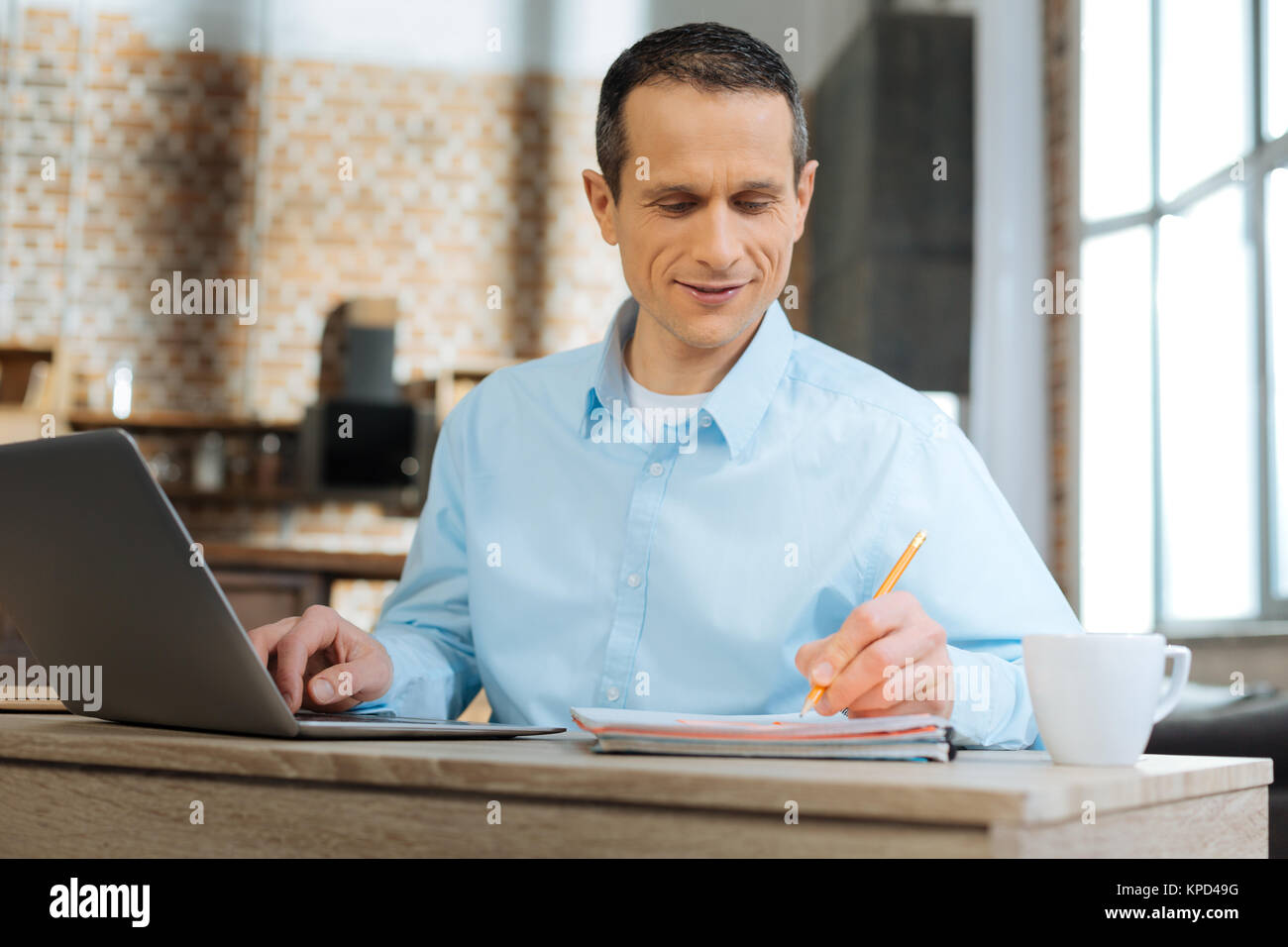 Concentrated male person doing his work Stock Photo - Alamy