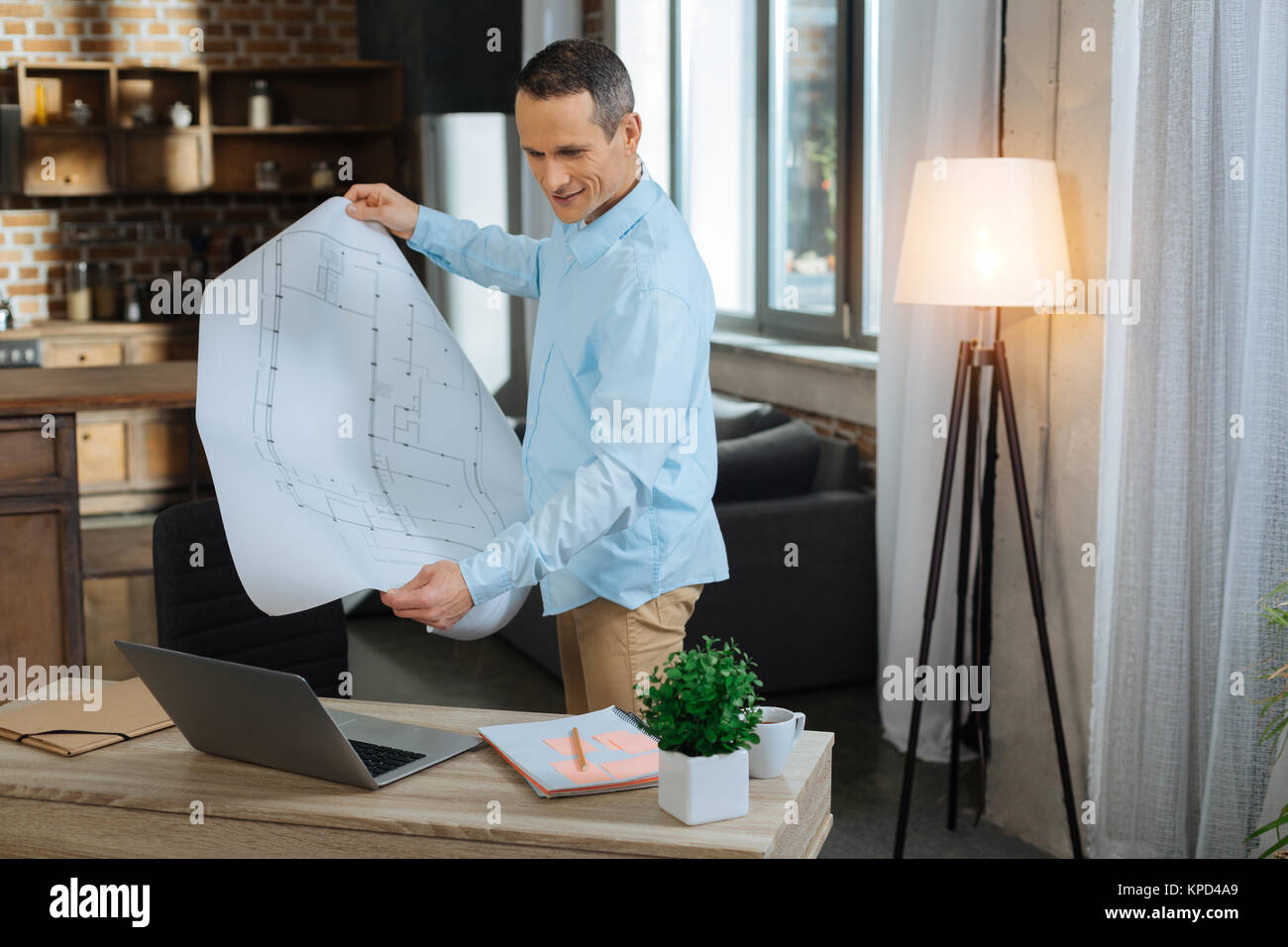 Happy man looking at his computer Stock Photo - Alamy