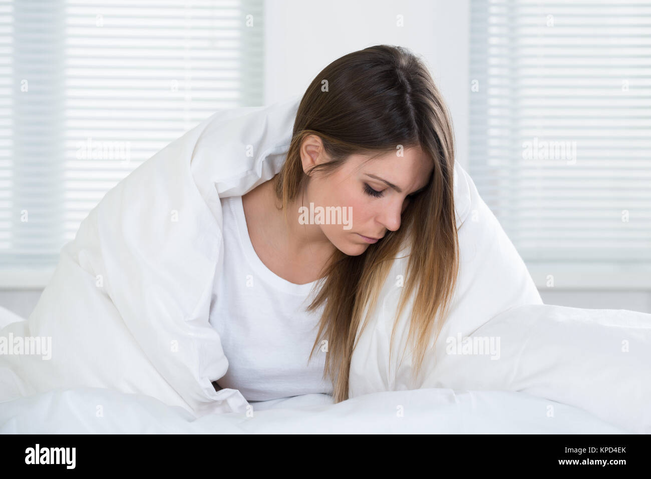 Young Woman Covered With Blanket Stock Photo - Alamy