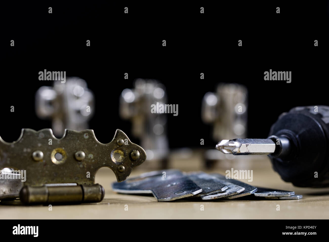 Carpentry tools and accessories on a workshop table. Hinges and screws ...