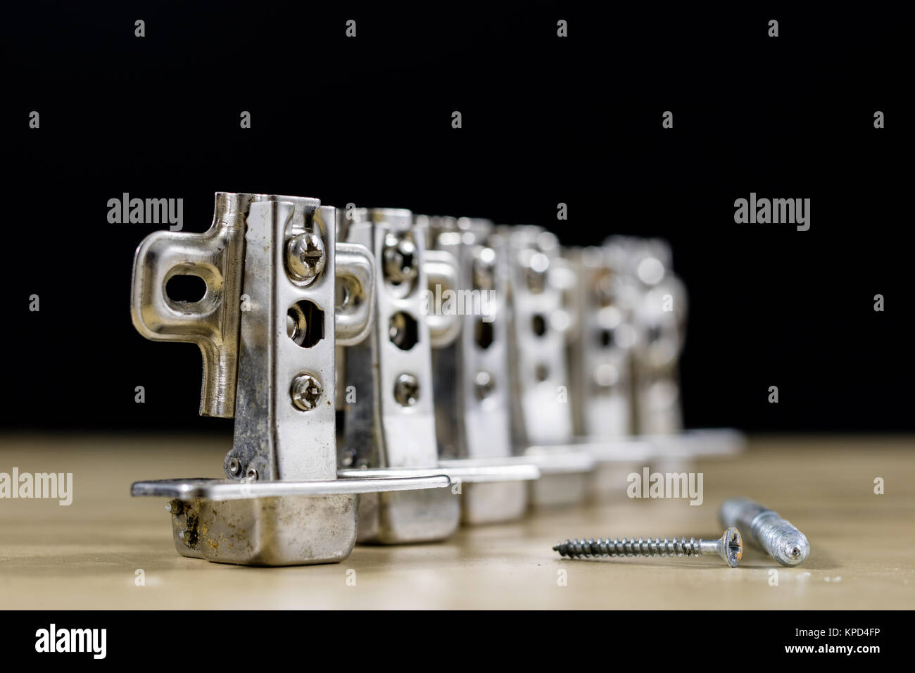 Carpentry tools and accessories on a workshop table. Hinges and screws ...