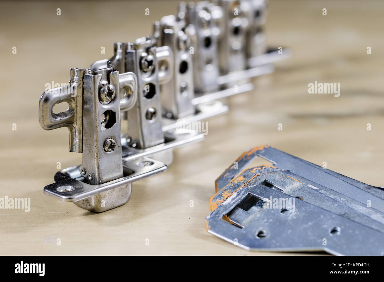 Carpentry tools and accessories on a workshop table. Hinges and screws ...