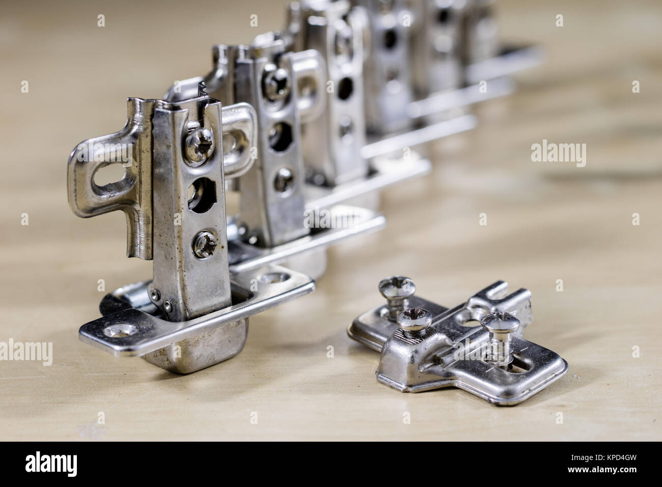 Carpentry tools and accessories on a workshop table. Hinges and screws ...