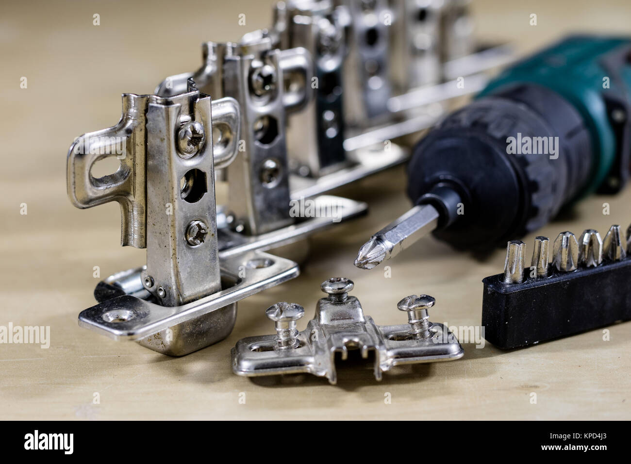 Carpentry tools and accessories on a workshop table. Hinges and screws ...
