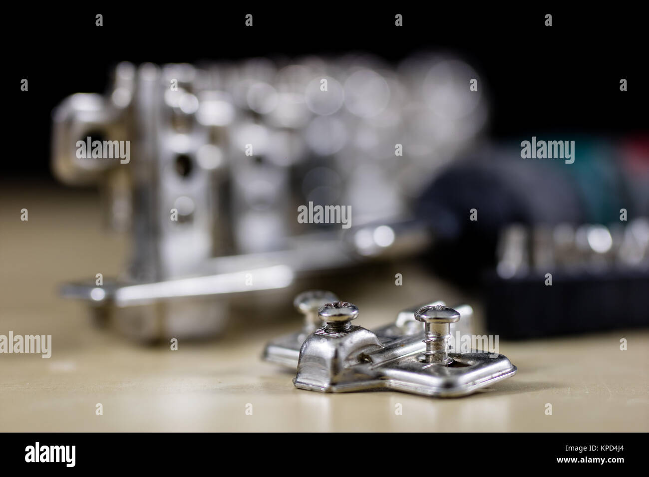 Carpentry tools and accessories on a workshop table. Hinges and screws ...