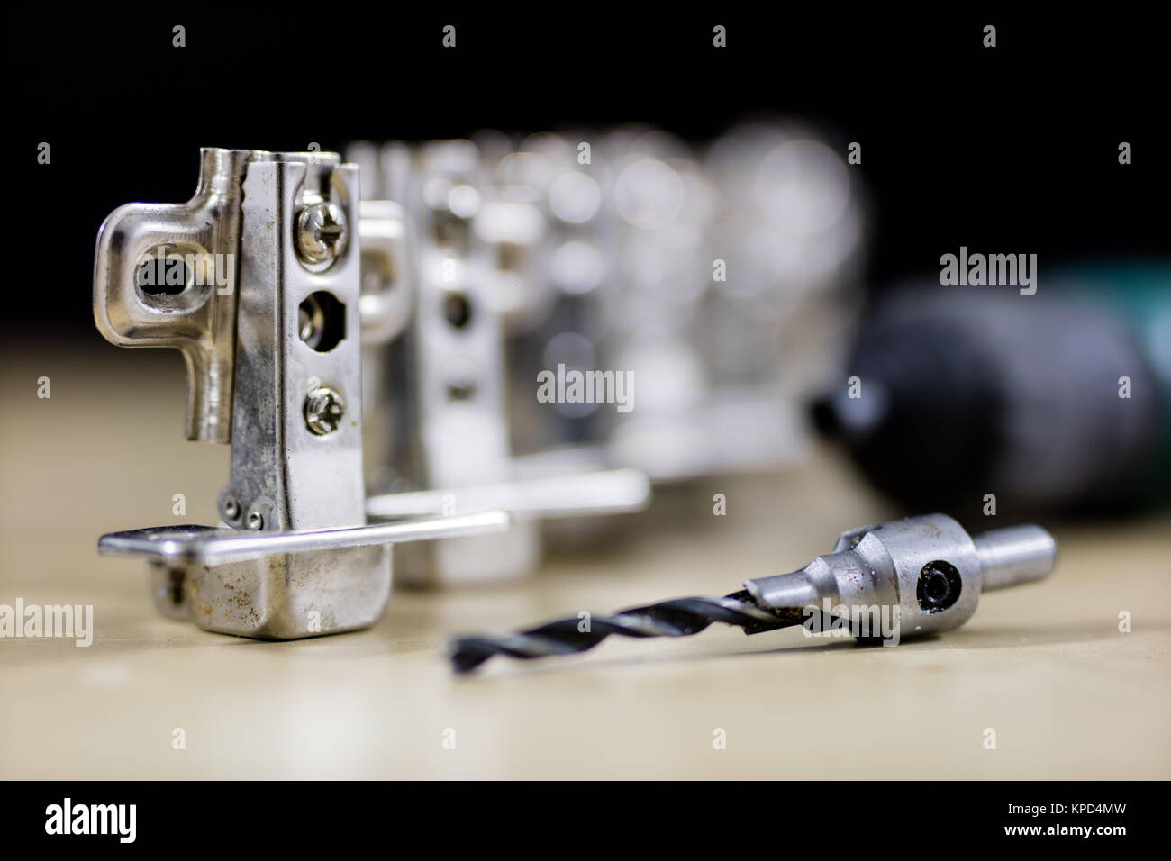Carpentry tools and accessories on a workshop table. Hinges and screws ...