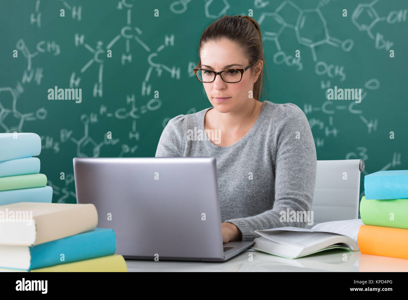 Woman Using Laptop In Classroom Stock Photo - Alamy