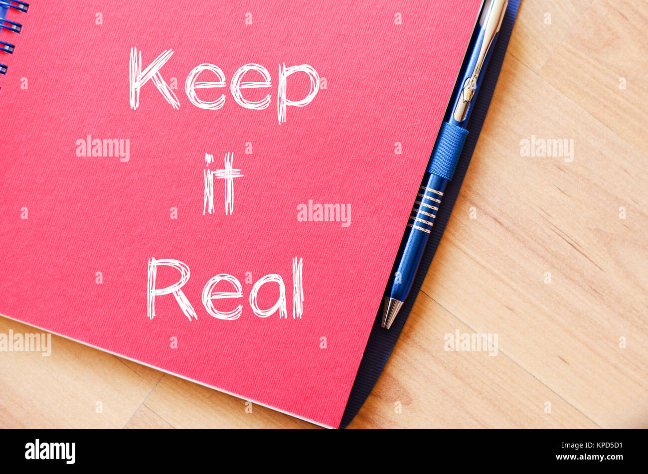 Keep it real write on notebook Stock Photo - Alamy