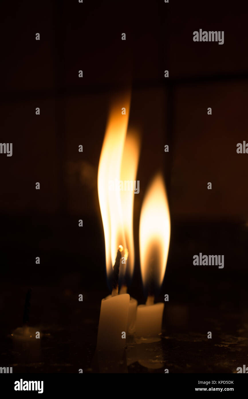 Burning candles with candle light in the dark Stock Photo - Alamy