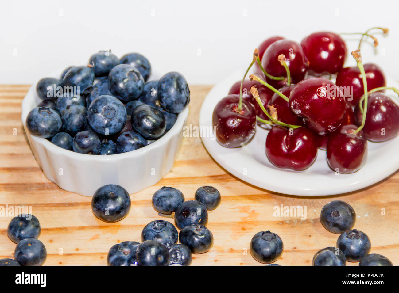 red fruits with rustic wood background Stock Photo - Alamy