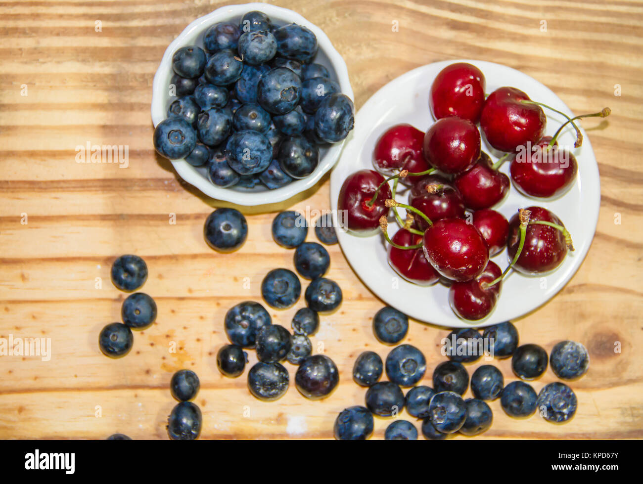 red fruits with rustic wood background Stock Photo - Alamy