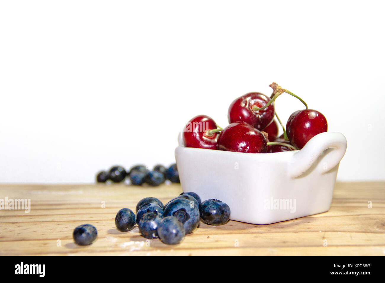 red fruits with rustic wood background Stock Photo - Alamy