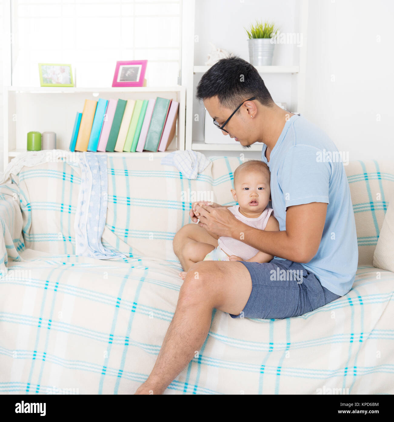 Tired father taking care baby at home Stock Photo - Alamy