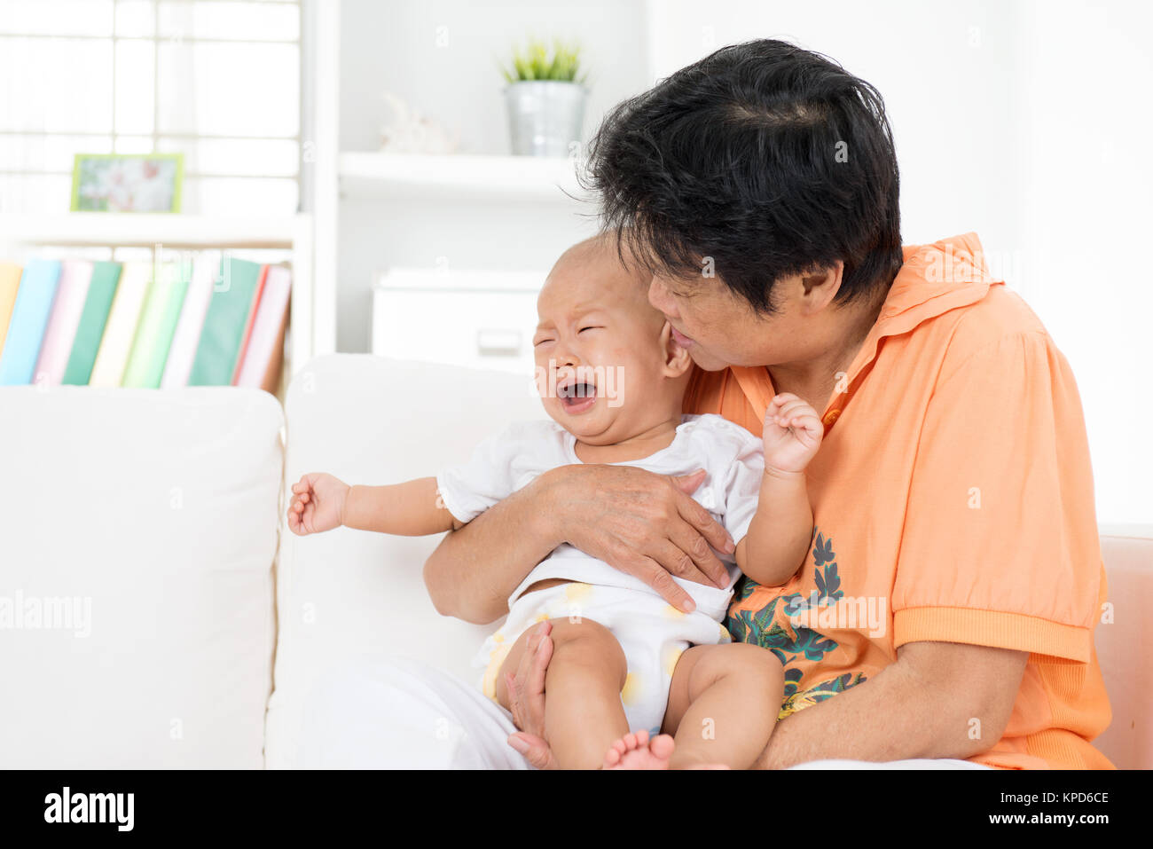 Comfort crying baby Stock Photo - Alamy