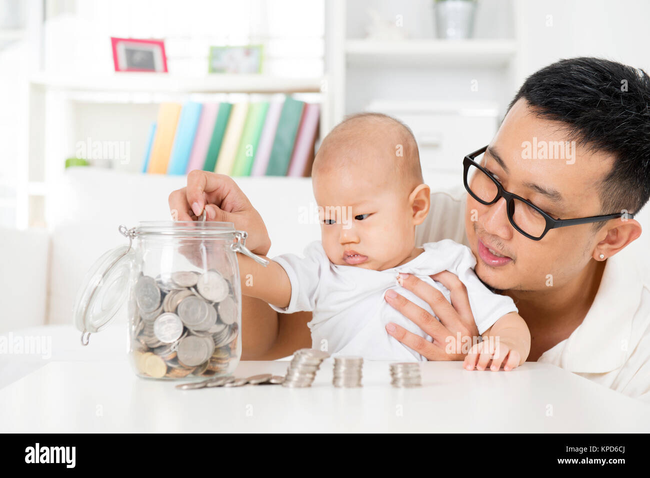 Father and baby saving money Stock Photo - Alamy