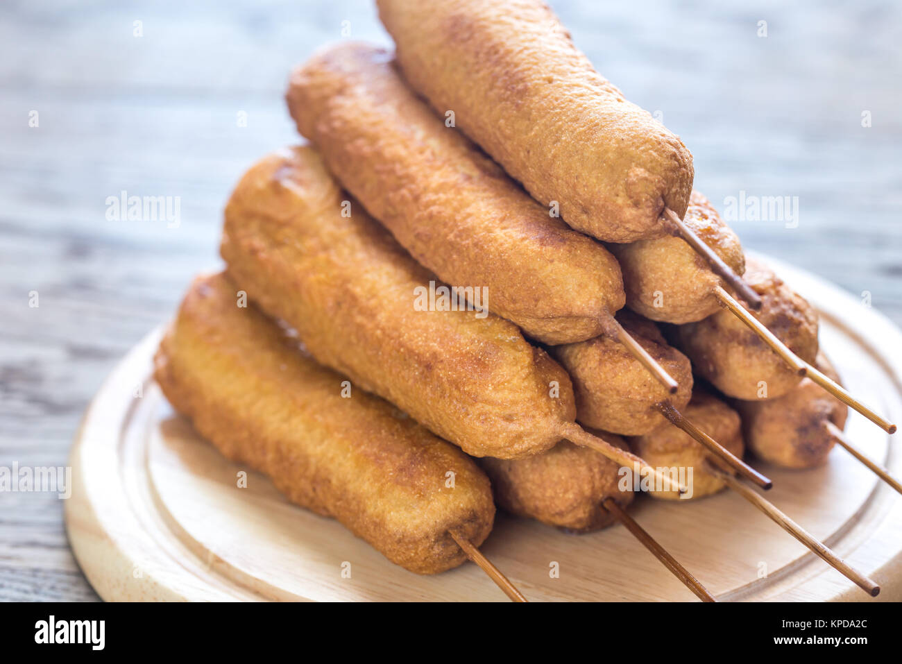 Stack of corn dogs on the wooden board Stock Photo - Alamy