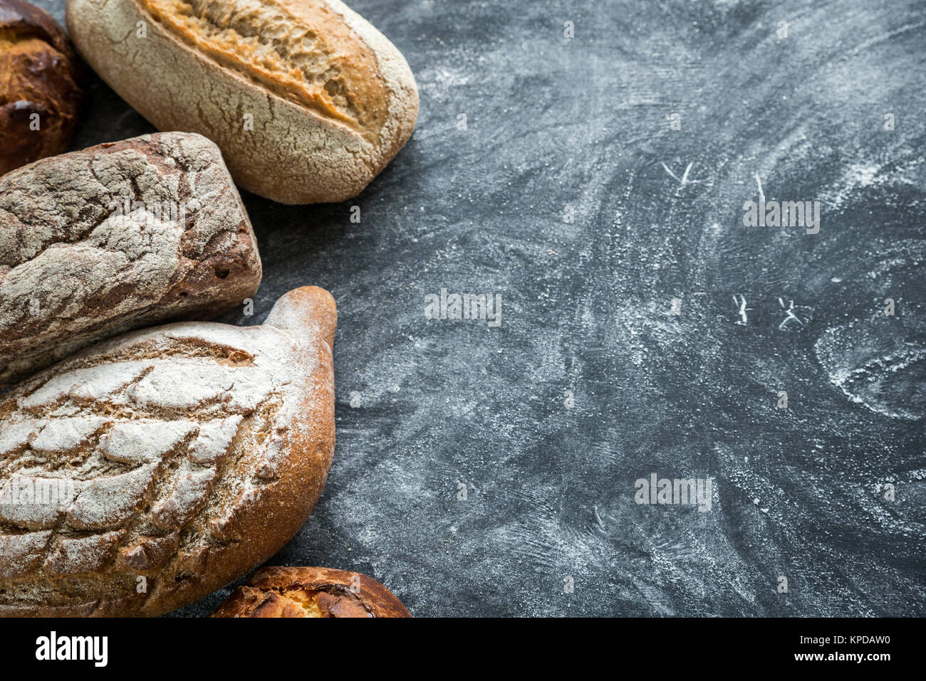 Whole grain breads on the dark wooden background Stock Photo - Alamy