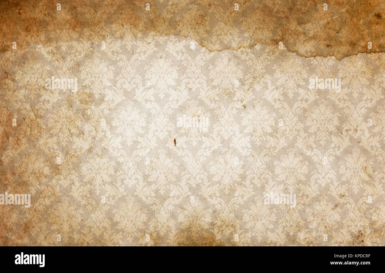 Dirty and spotted paper with vintage decorative ornament. Old wallpaper ...