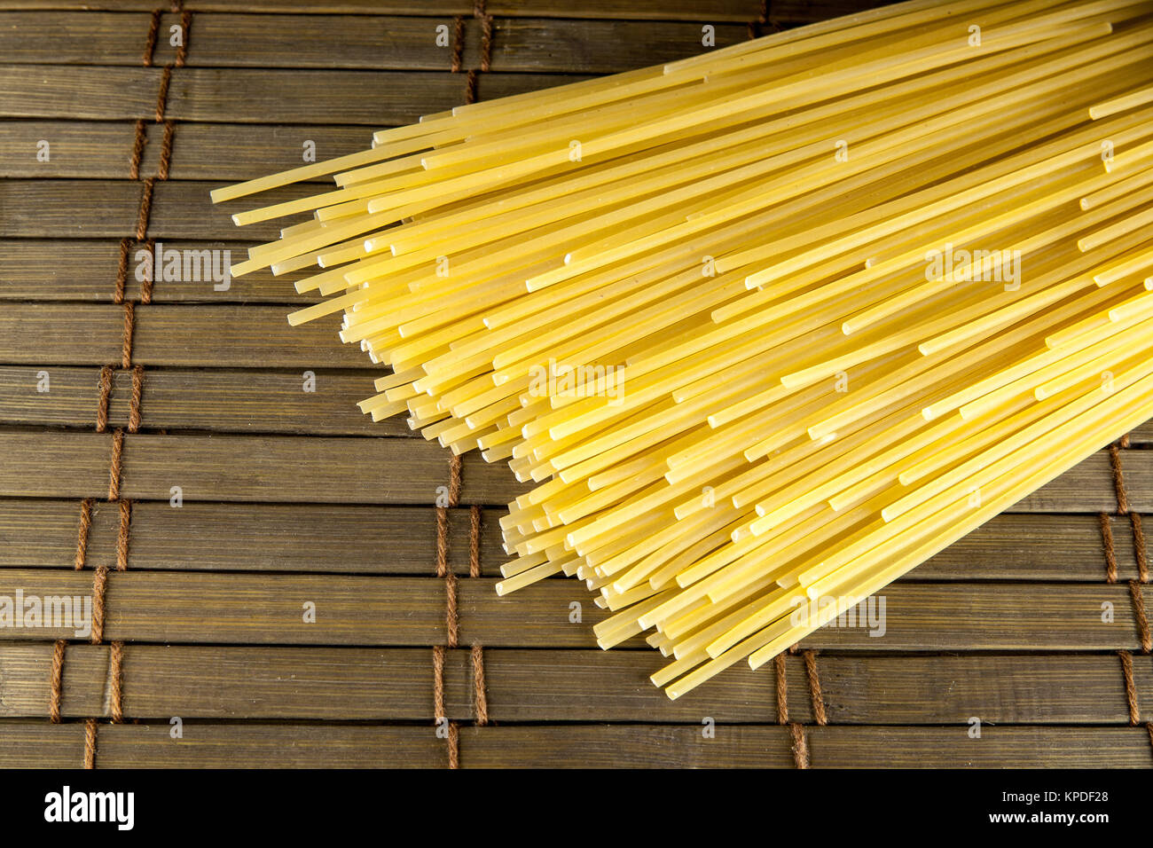 Bunch of spaghetti on wooden table background Stock Photo - Alamy