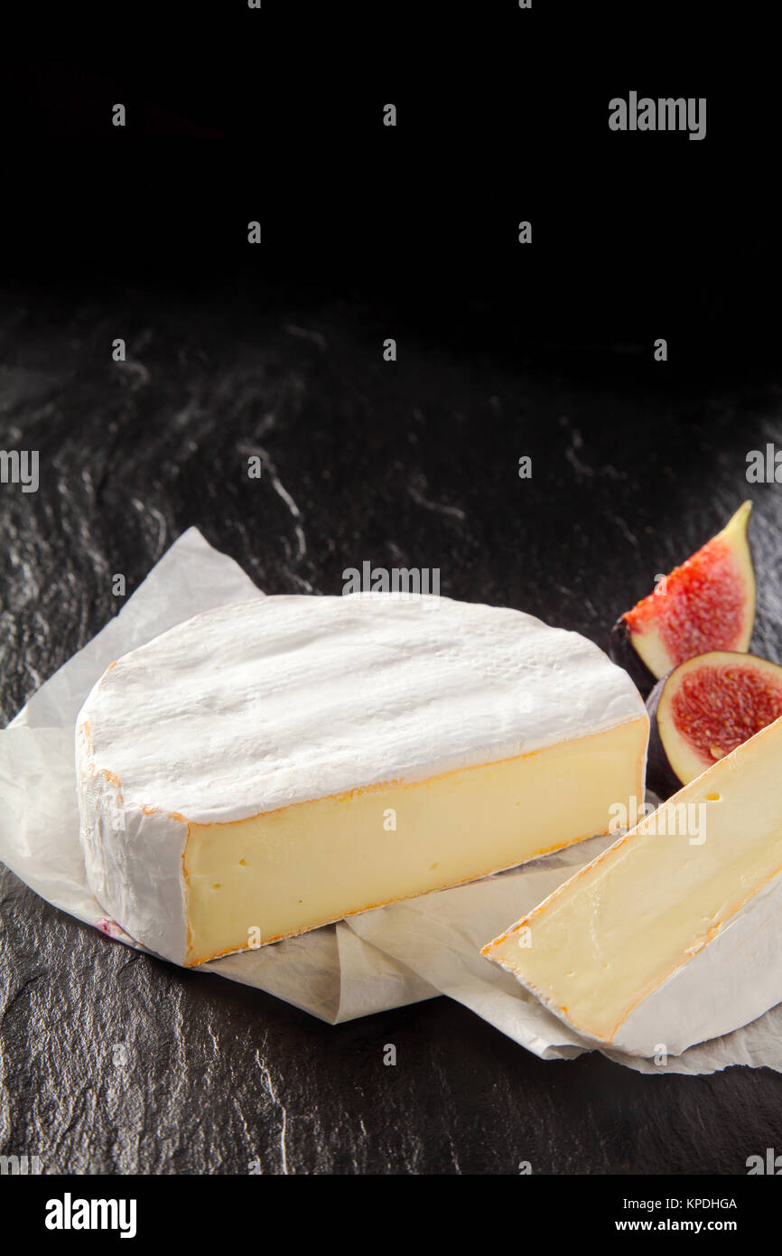 Gourmet ripe soft French Camembert cheese sliced through to show the ...