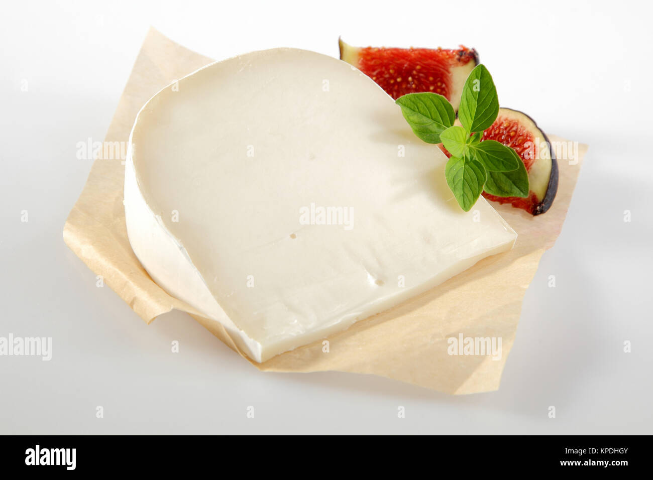 Slice of healthy white semi-hard goat cheese with sliced ripe fresh ...