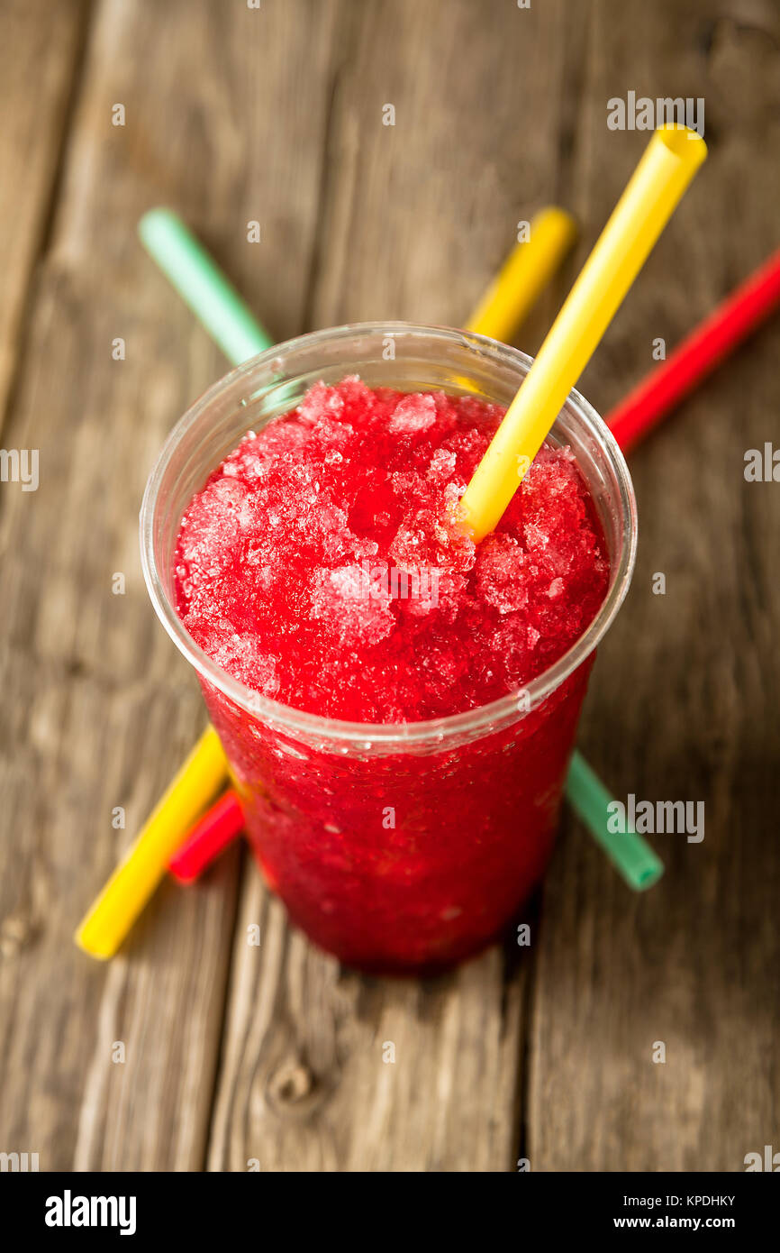 frozen red slushie in plastic cup with straw Stock Photo - Alamy