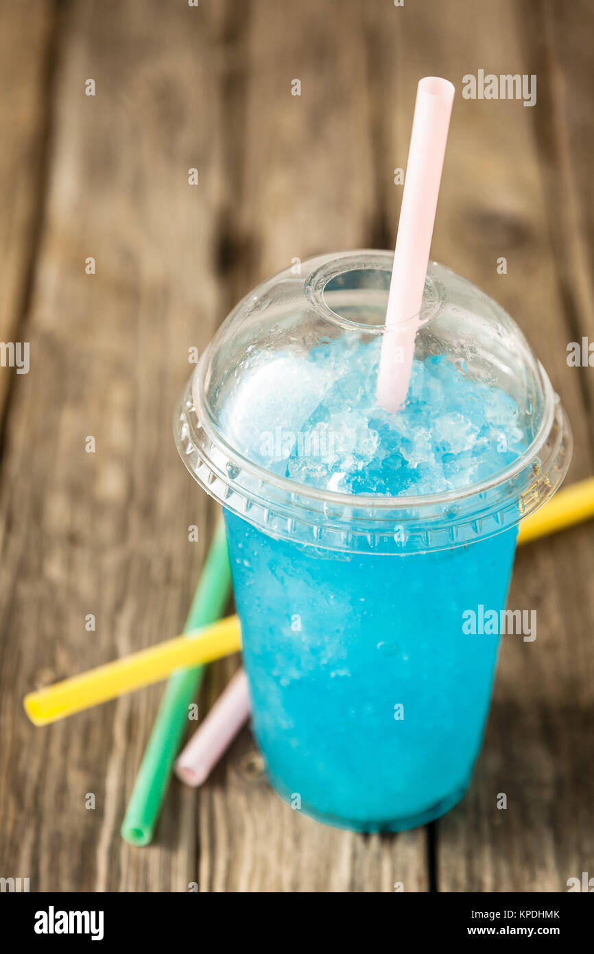 frozen blue slushie in plastic cup with straw Stock Photo - Alamy
