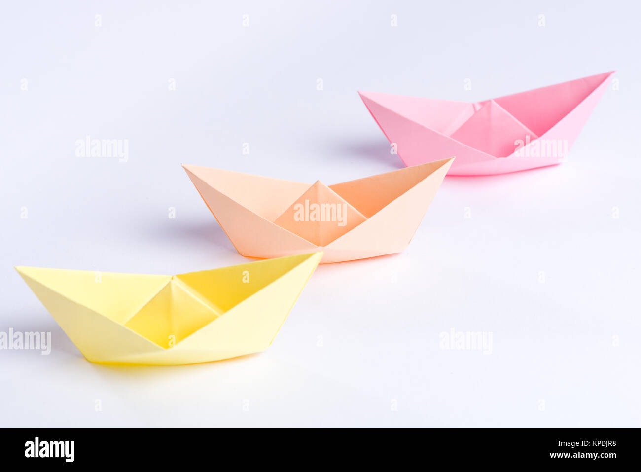 Three origami paper ships in pastel colors isolated on white Stock ...