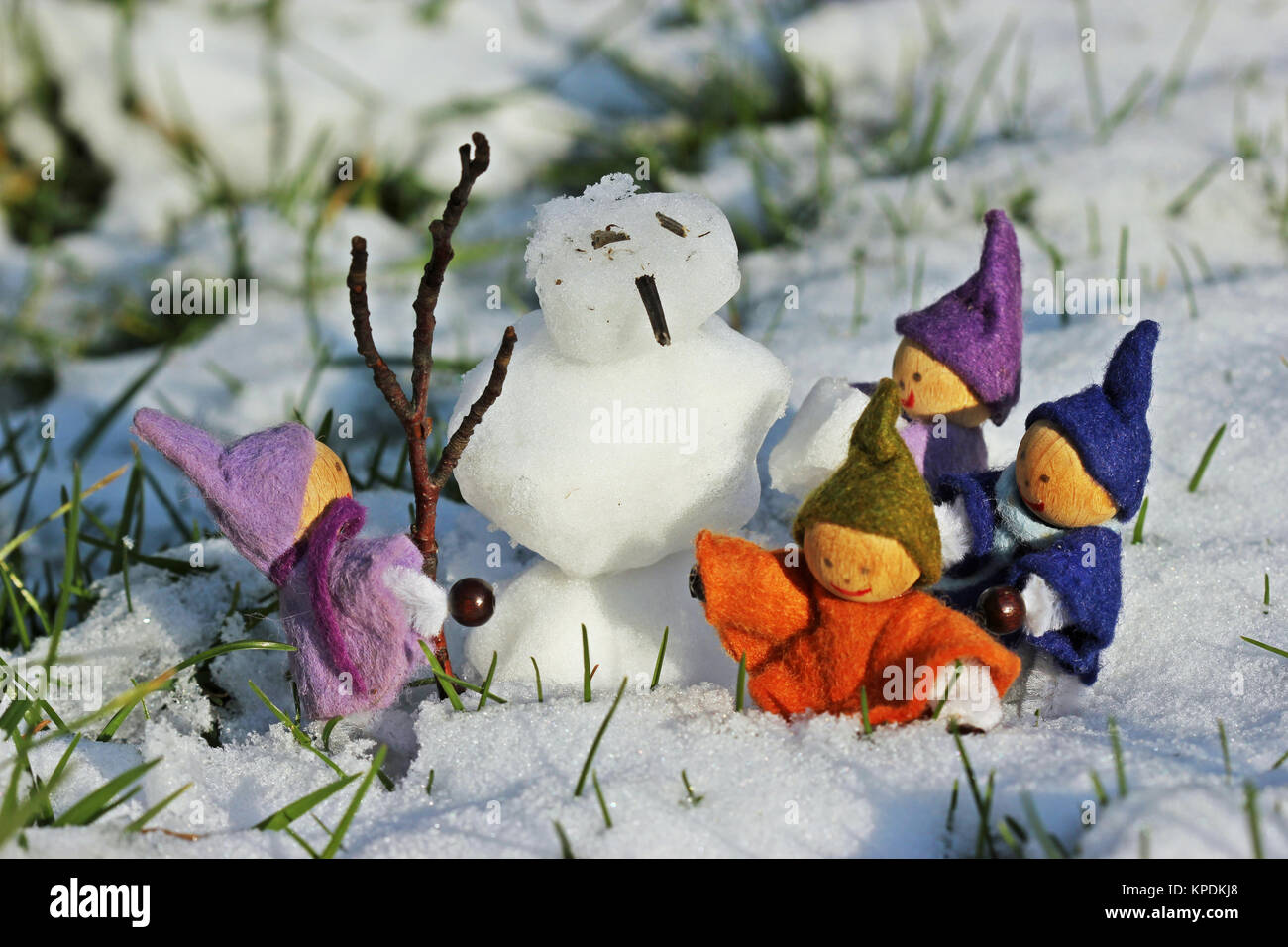 four little elves build a snowman Stock Photo - Alamy