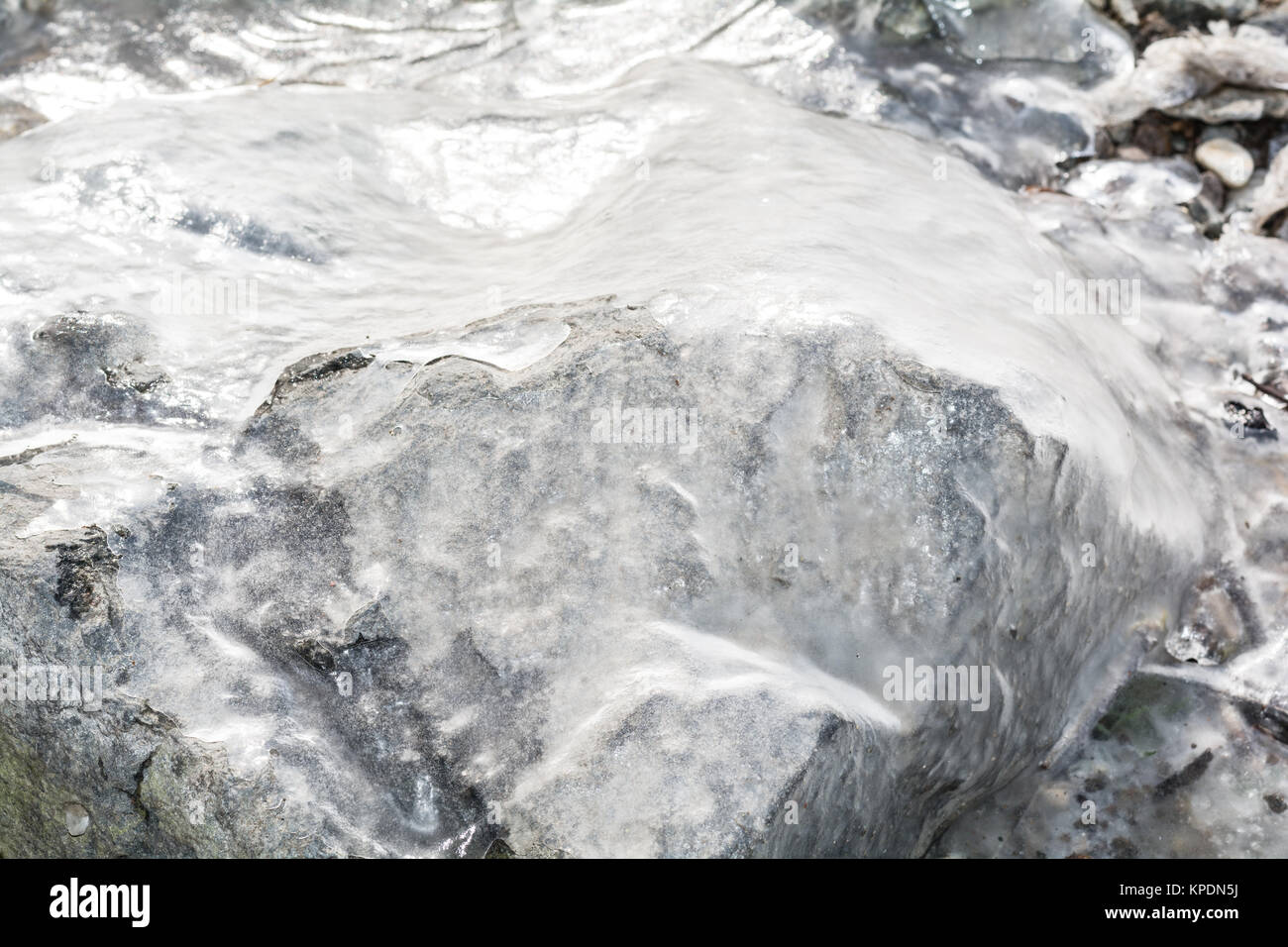 Frozen rocks with ice in the winter lake Stock Photo - Alamy