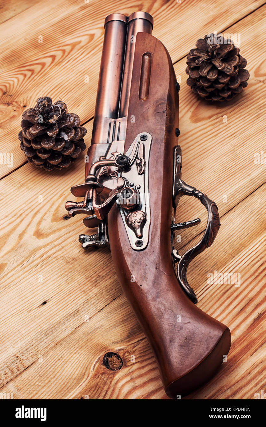 Old hunting musket on a light wooden background with forest cones Stock ...