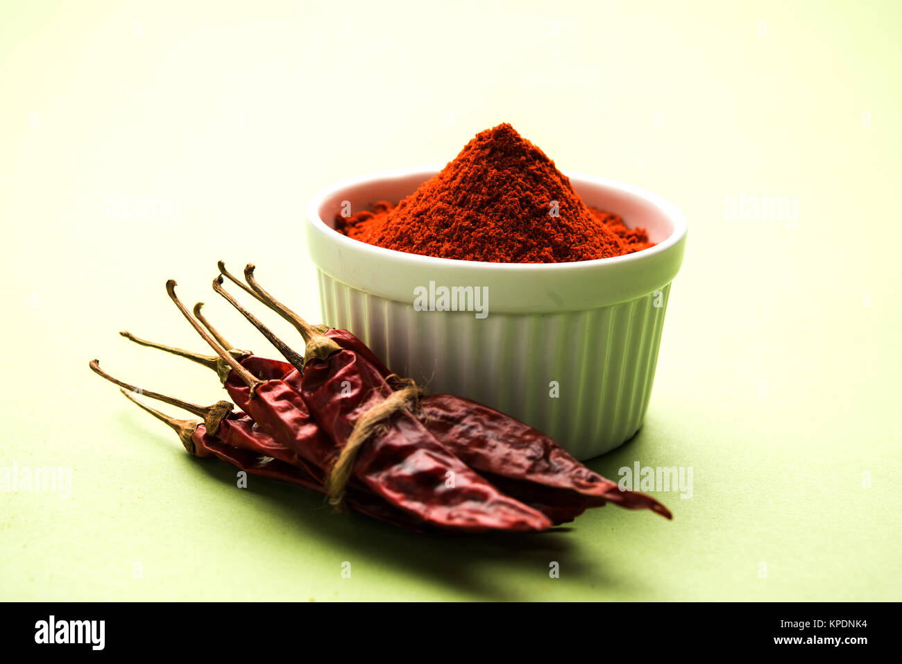 Red Chilly Powder in a bowl with dried red chillies over colourful ...