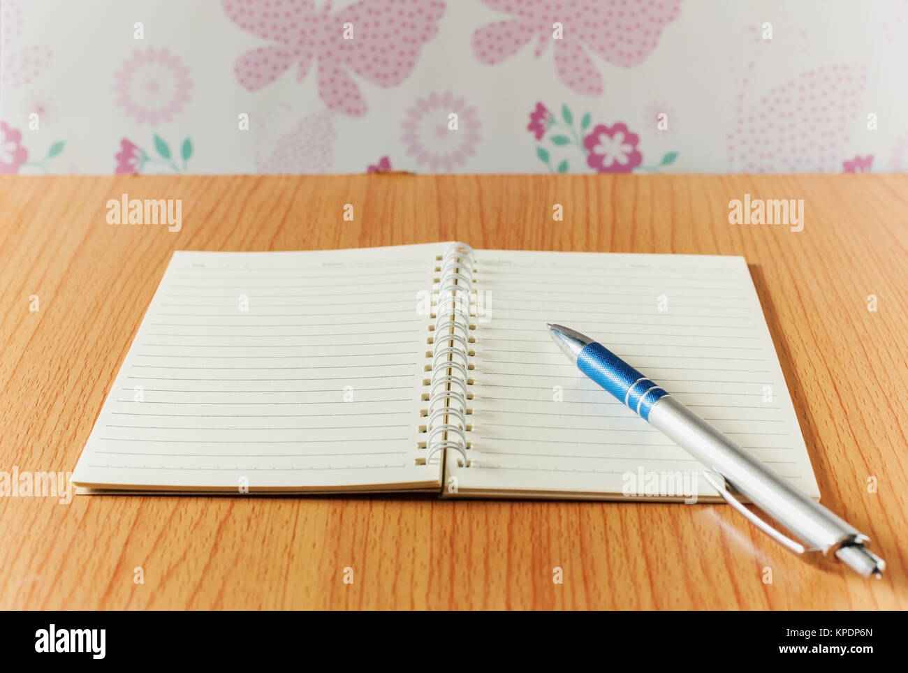 Notepad with a pen on office table Stock Photo - Alamy