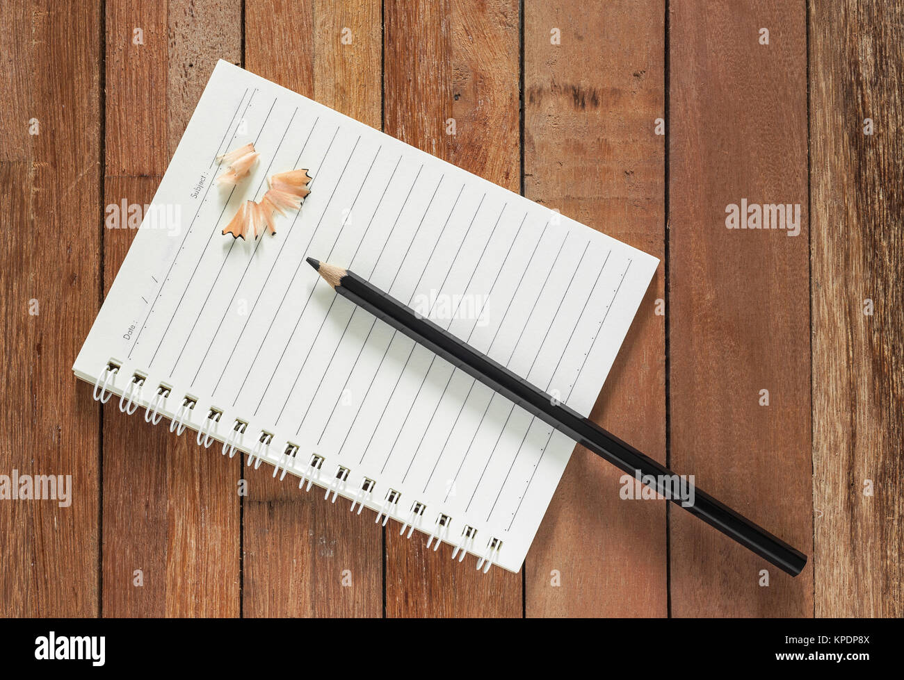 Paper note with pencil on wooden Stock Photo - Alamy