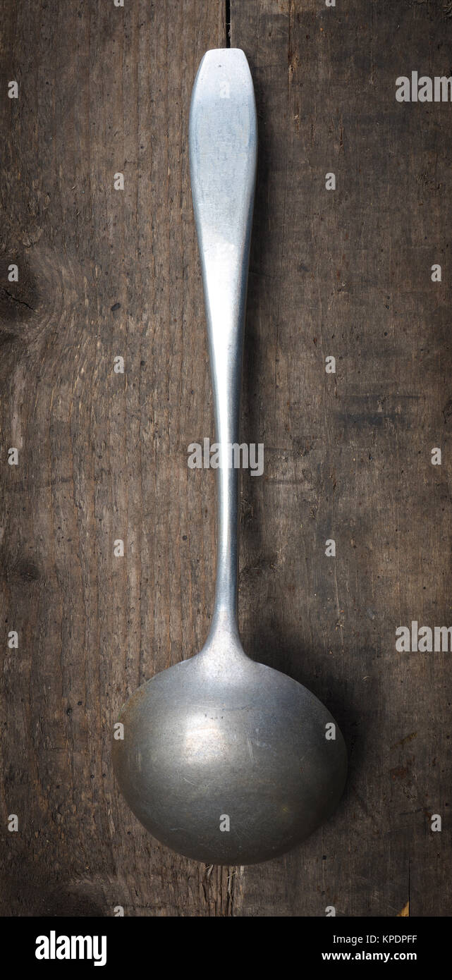 Old used spoon on a rustic wooden table Stock Photo - Alamy