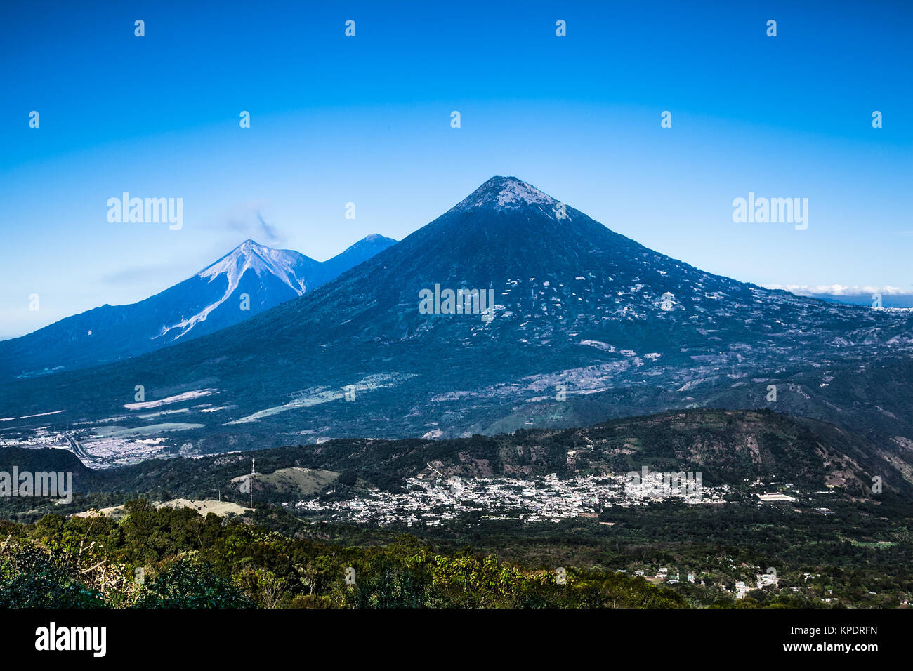 Volcans Aqua, Acatenango and Fuego (Fire volcano) erupts a cloud of ash ...