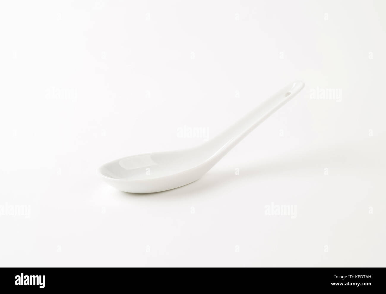 White porcelain appetizer spoon Stock Photo - Alamy